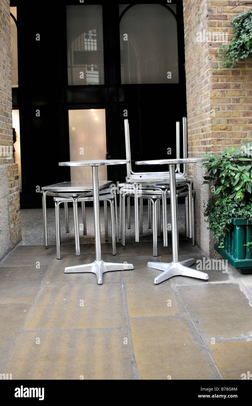 Stacked tables of and outdoor restaurant Stock Photo - Alamy