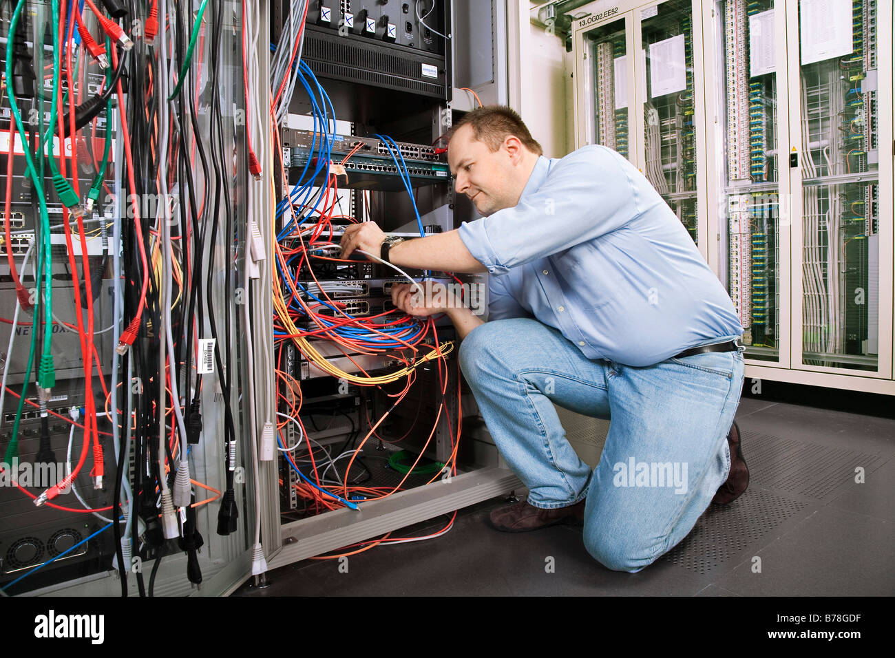 IT technician and engineer examining and repairing a server of Messe ...