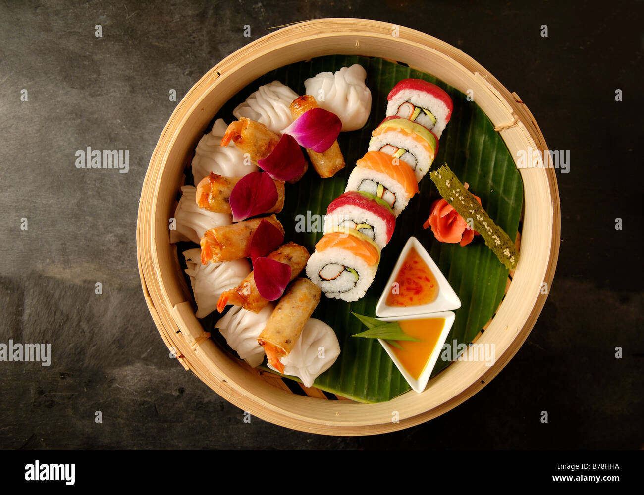 "Apéro", Dim sum, spring rolls and california rolls on a banana leaf ...