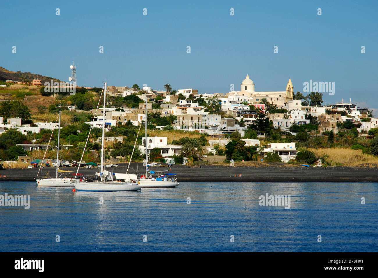 Sailing boats anchored at a white village on Stromboli Island ...