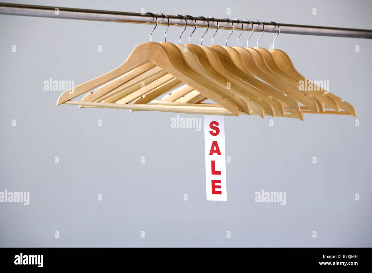 Hangers on hanger rack with sale sign Stock Photo - Alamy