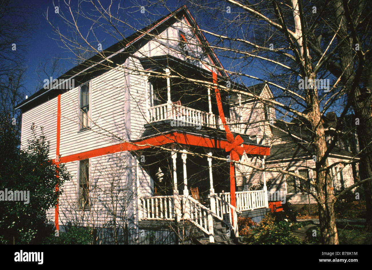 House wrapped as a gift in a ribbon Stock Photo - Alamy