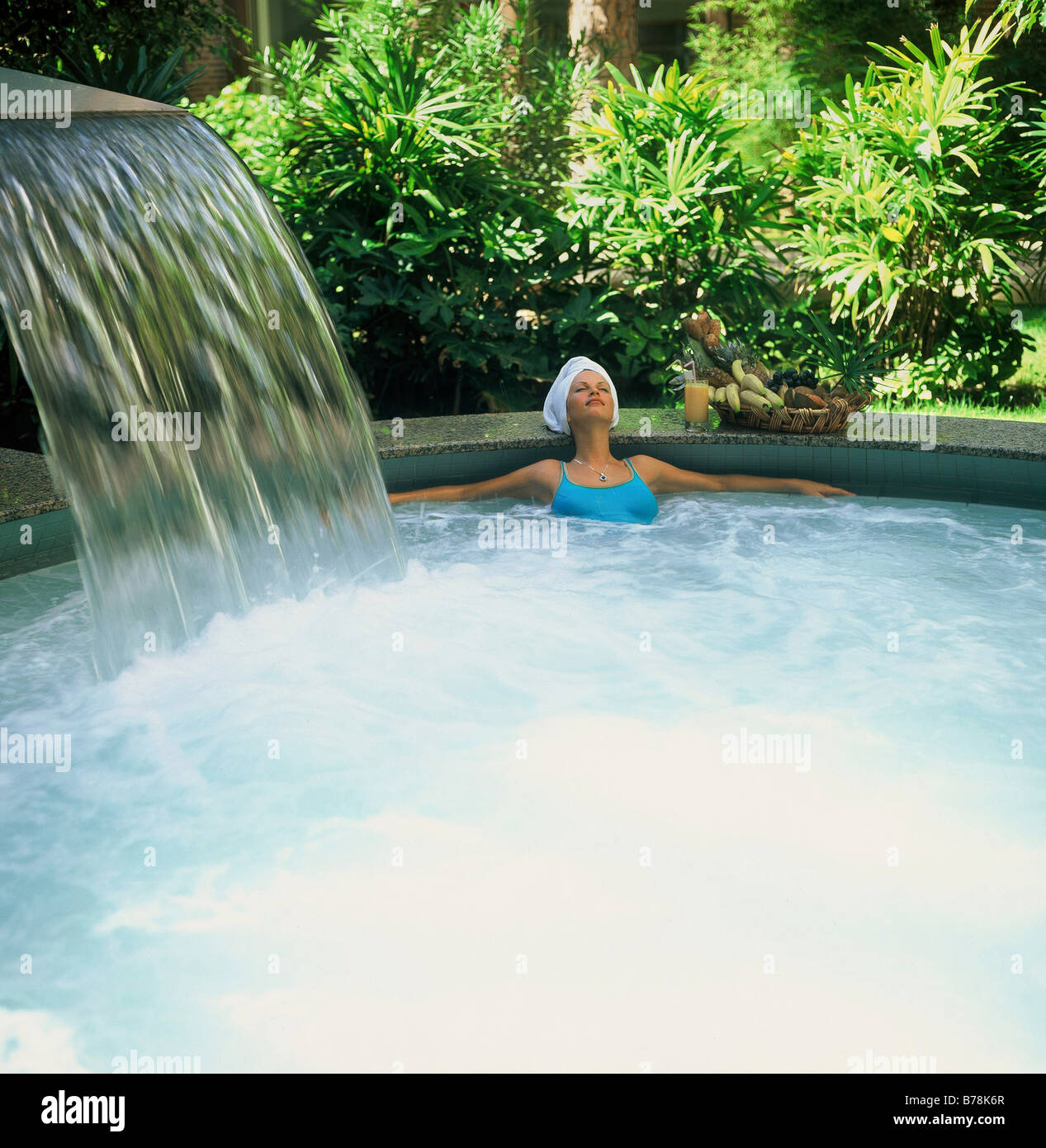 Woman relaxing in pool Stock Photo - Alamy