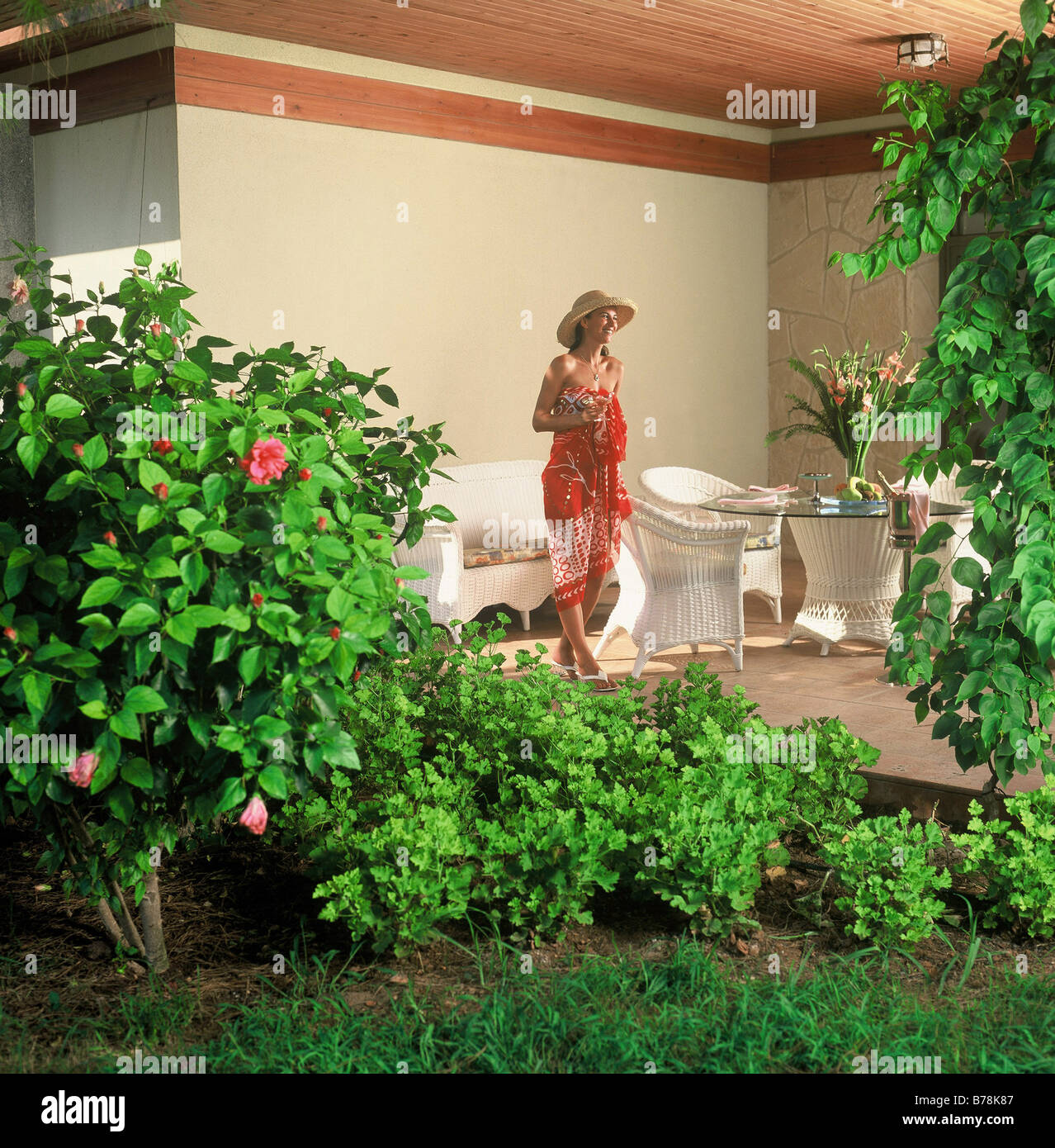 Woman relaxes on patio Stock Photo - Alamy