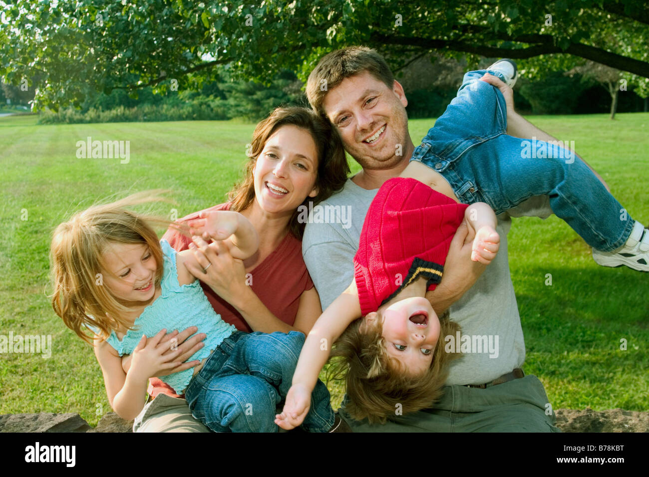 Parents posing with their young daughter and son. MODEL RELEASED Stock ...