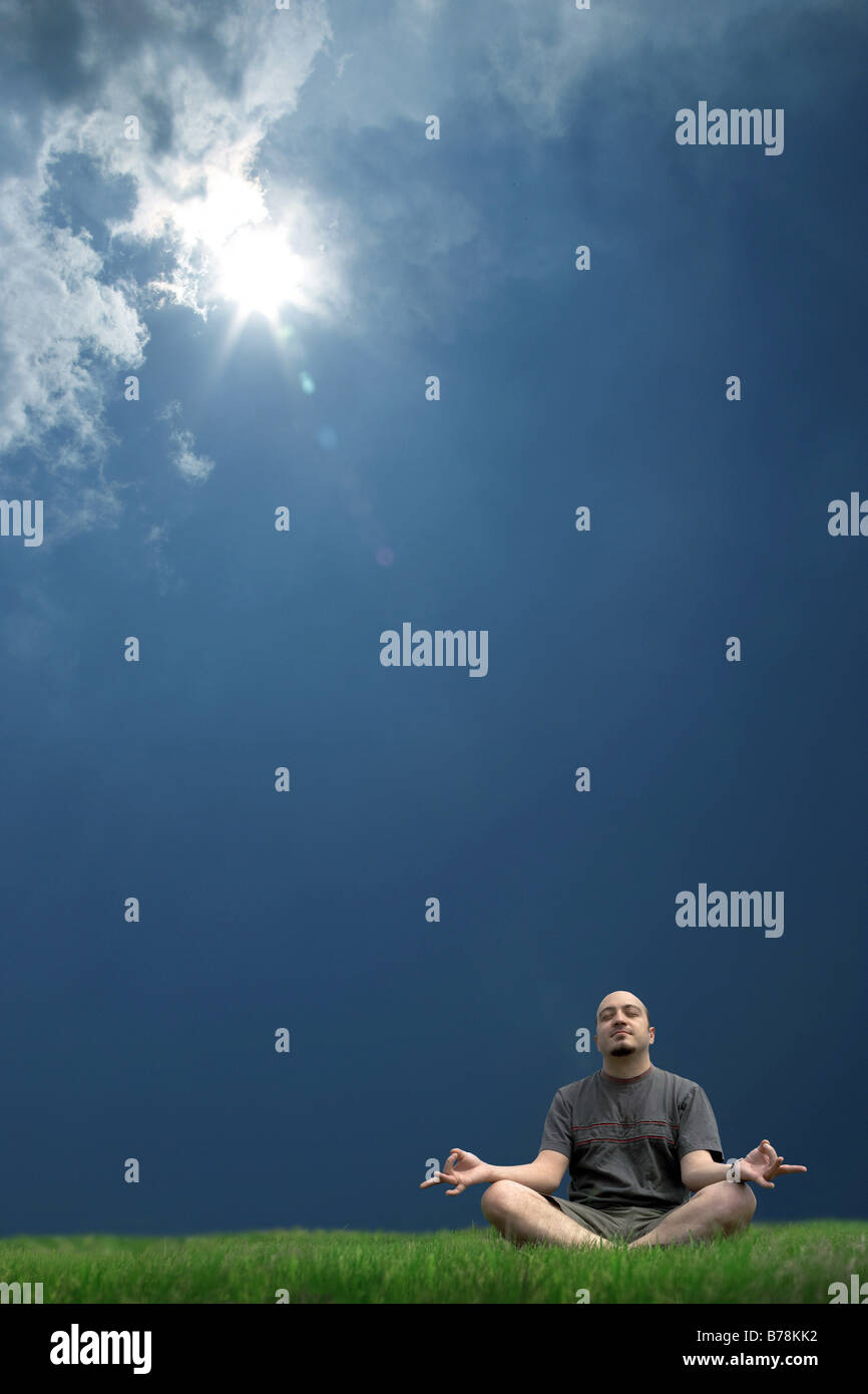 Man meditates outdoors Stock Photo - Alamy