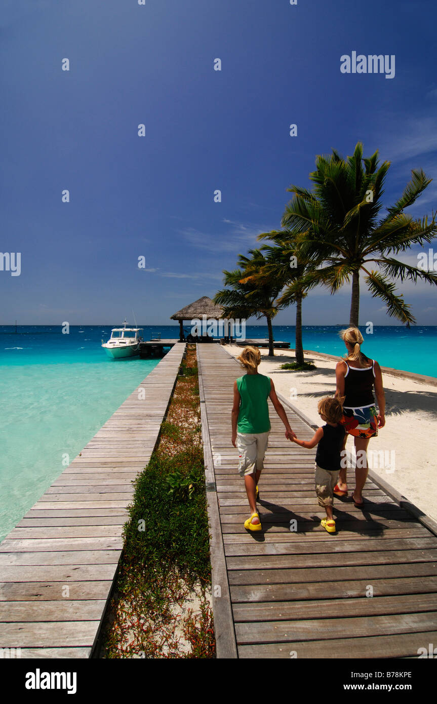 Woman and two children walking along the jetty, Laguna Resort, The ...