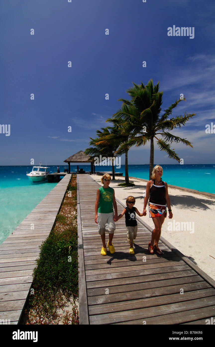 Woman and two children walking along the jetty, Laguna Resort, The ...