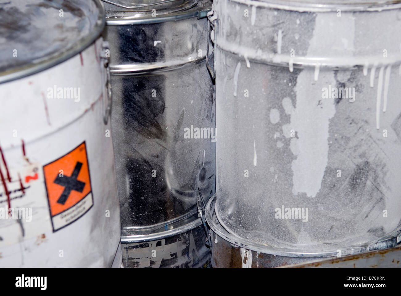 Warning sign on metallic paint buckets, close-up Stock Photo - Alamy