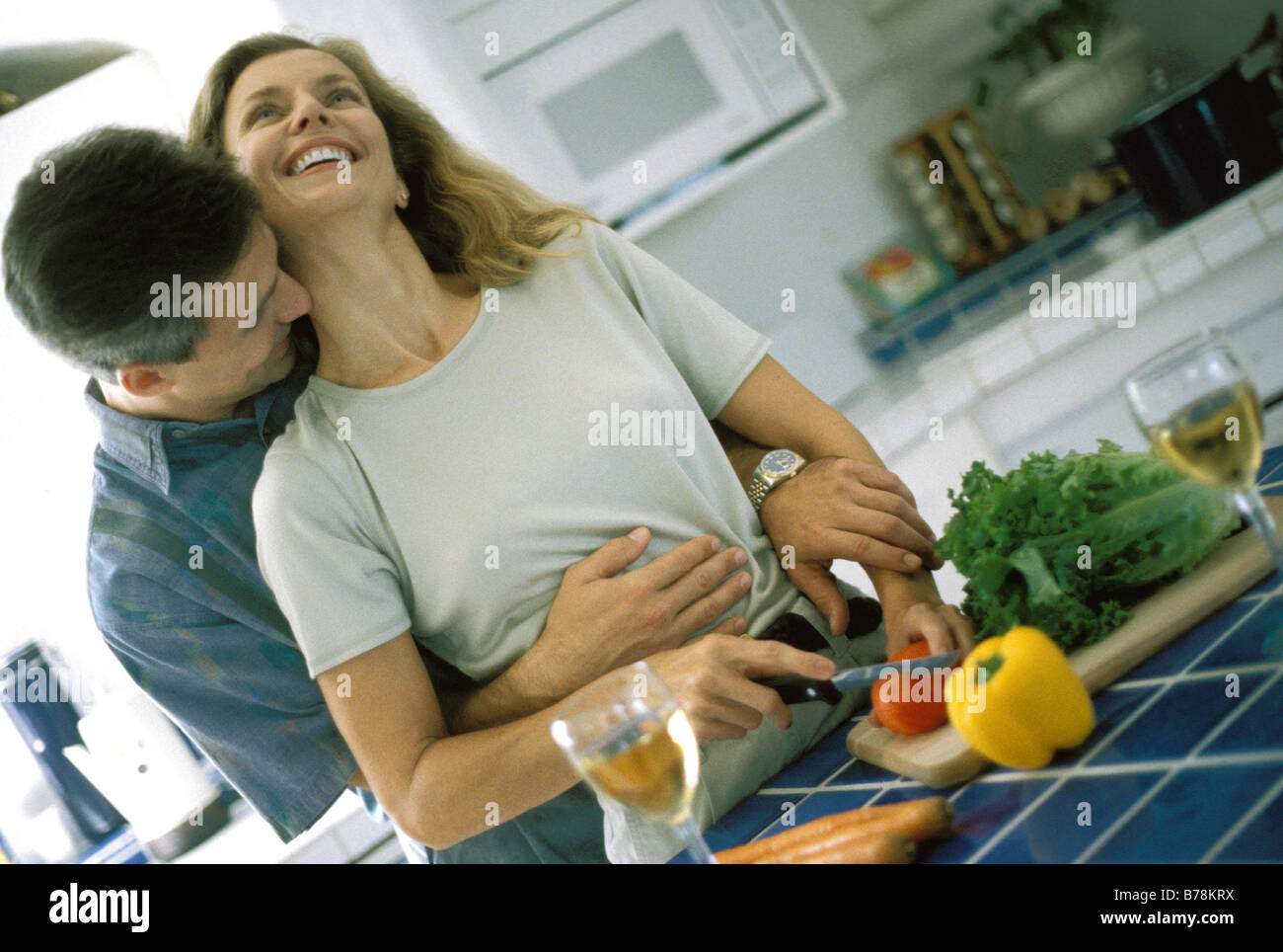 Romantic couple in kitchen Stock Photo - Alamy