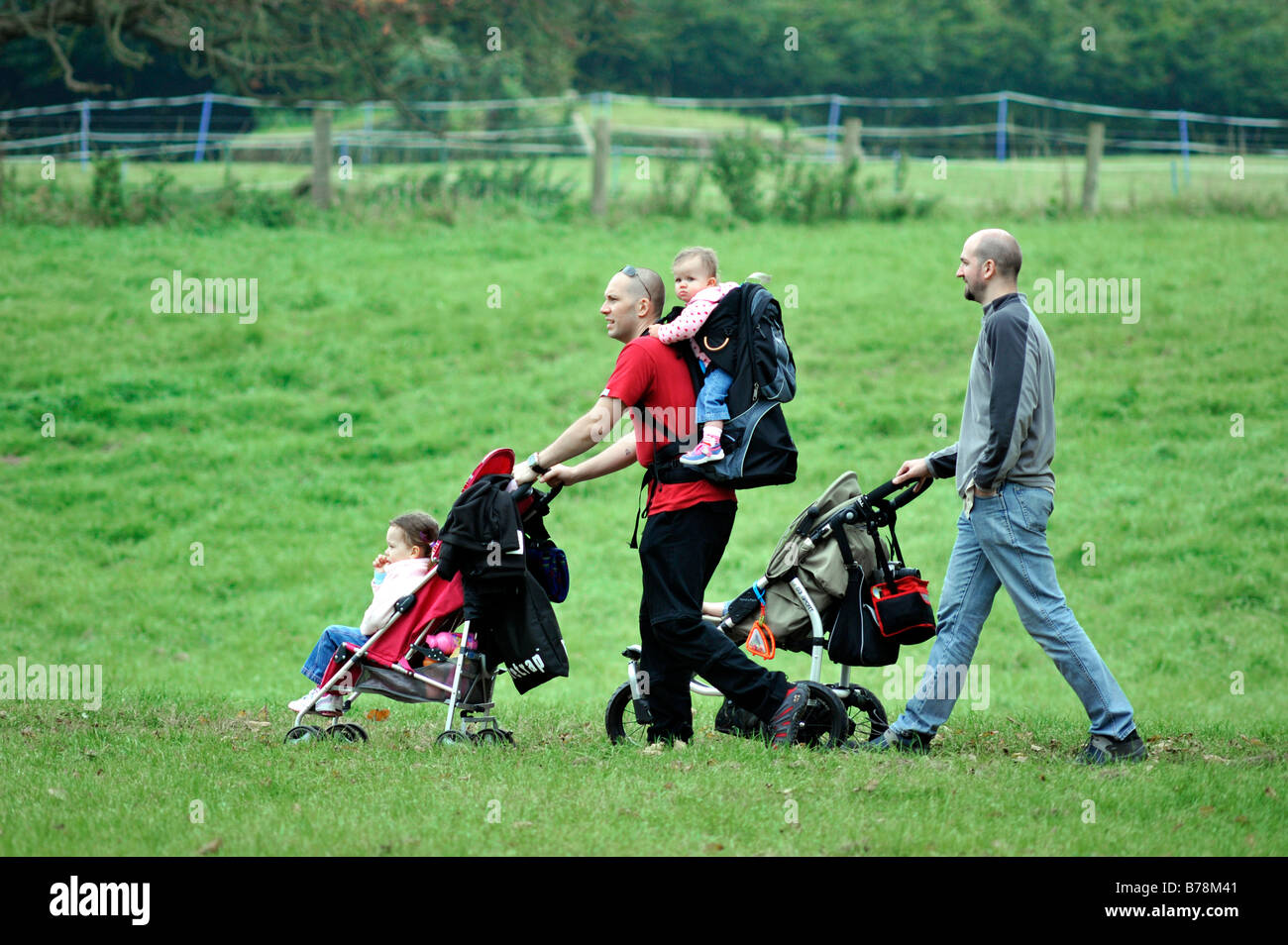 two family men with children in meadow Stock Photo - Alamy