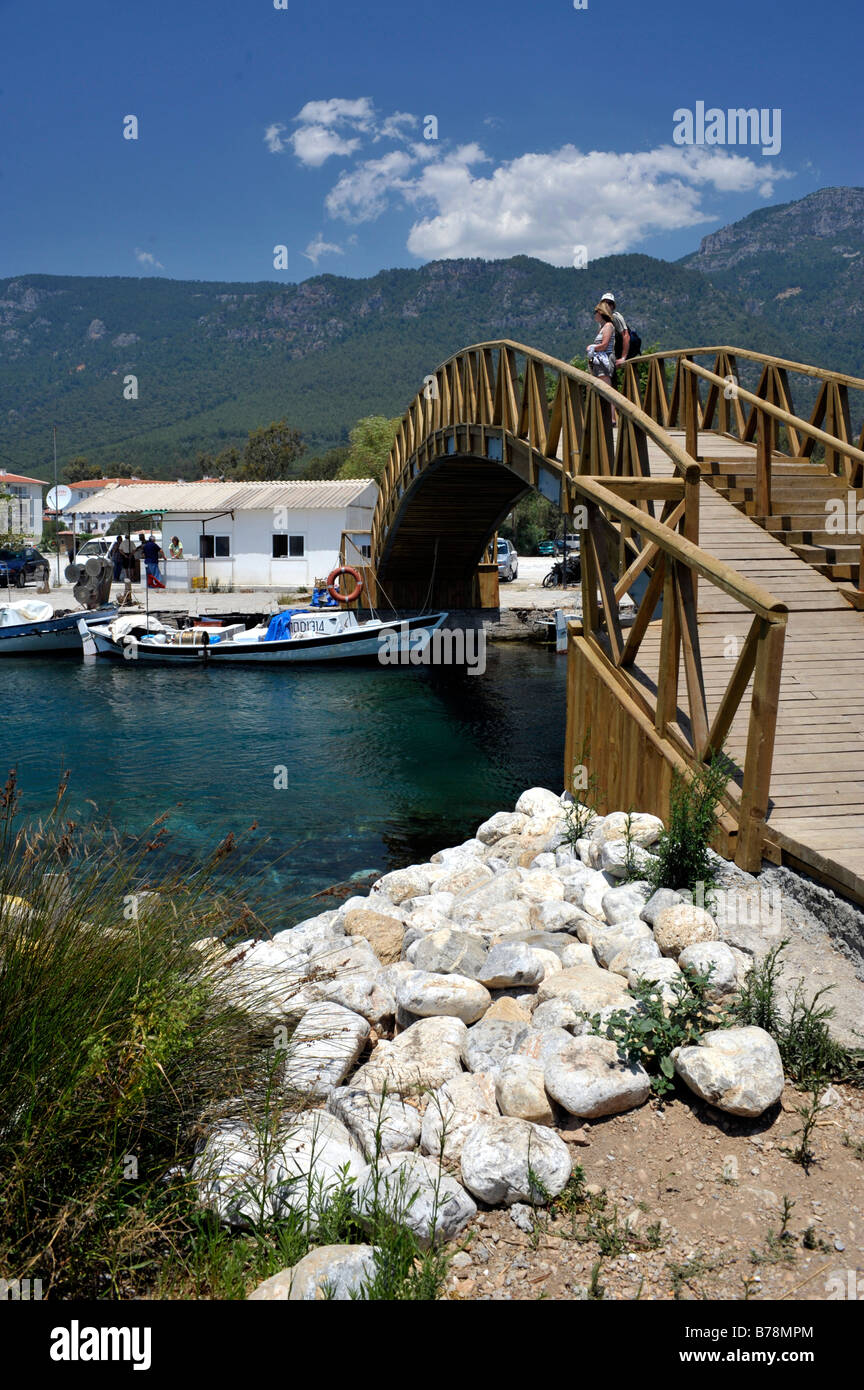 man and woman standing on wooden arching bridge looking over Azmak ...