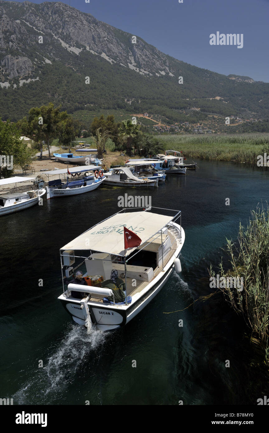 motor boat travelling up Azmak river Akyaka Turkey on the Bodrum ...