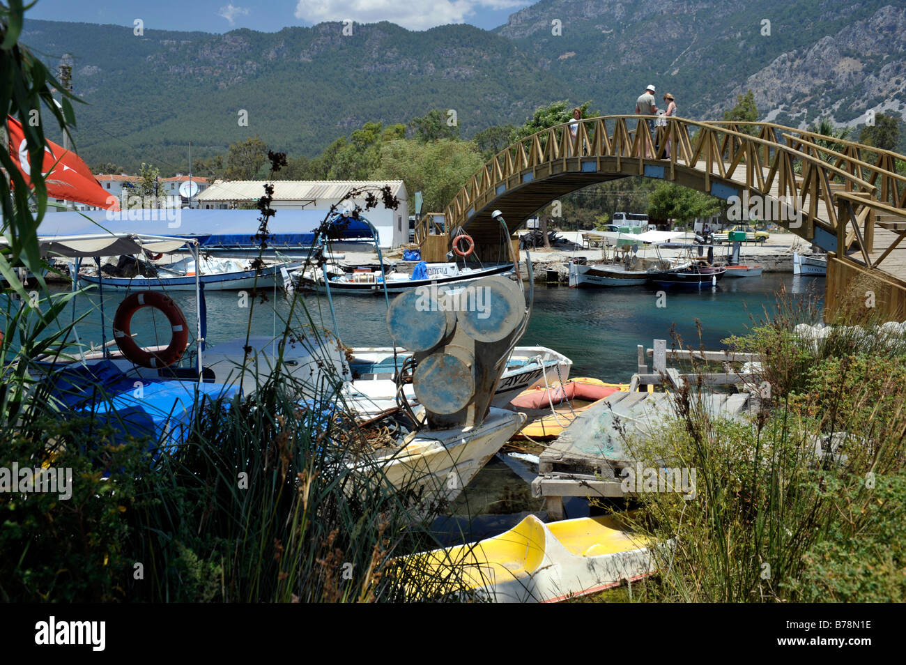 man and woman standing on wooden arching bridge looking over Azmak ...