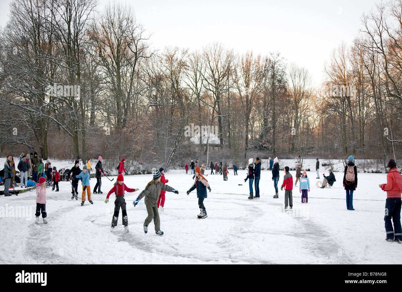 kids Ice skating on a lake Stock Photo - Alamy