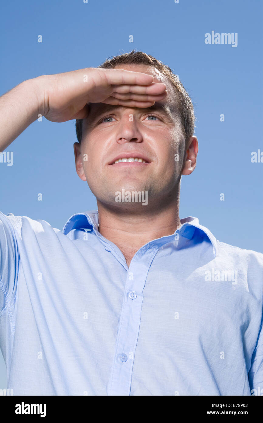 Young man watching out for something, portrait Stock Photo - Alamy