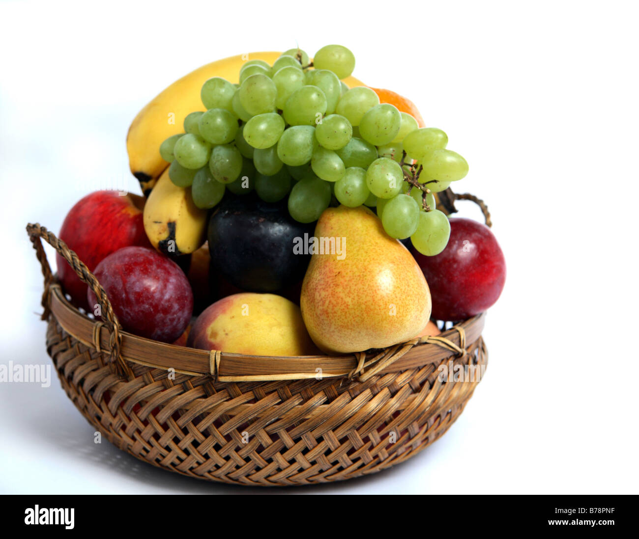 A basket of fruit on a white background Stock Photo - Alamy