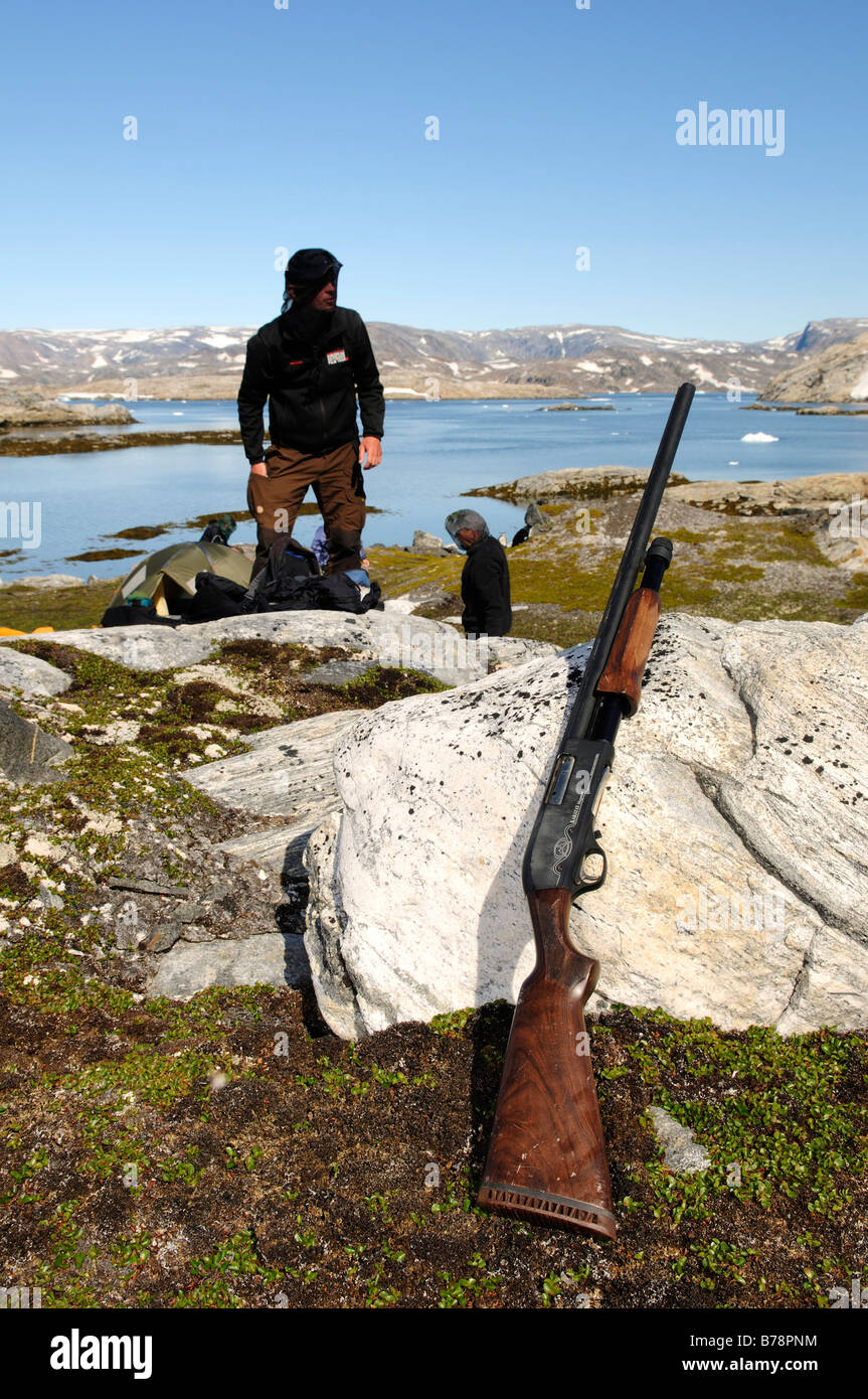 Trekker checking his shotgun for defence against polar bears ...