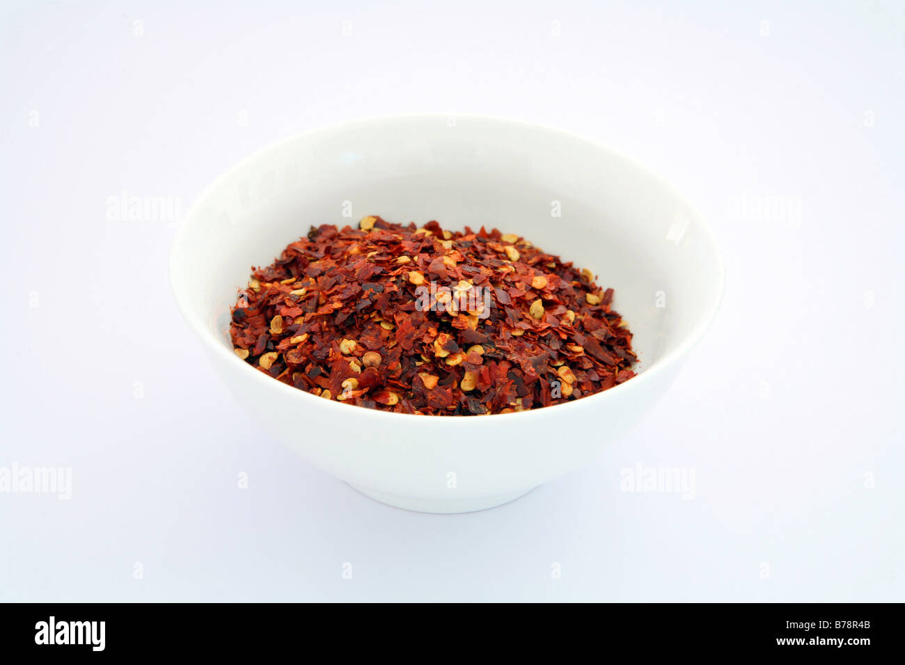 A bowl of crushed indian chillies Stock Photo - Alamy