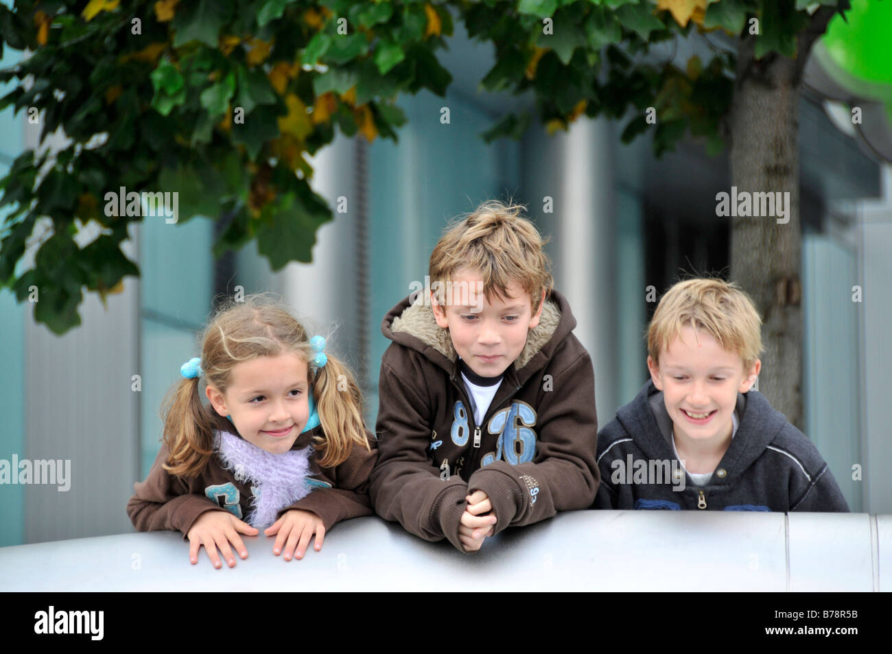 Three children smiling Stock Photo - Alamy