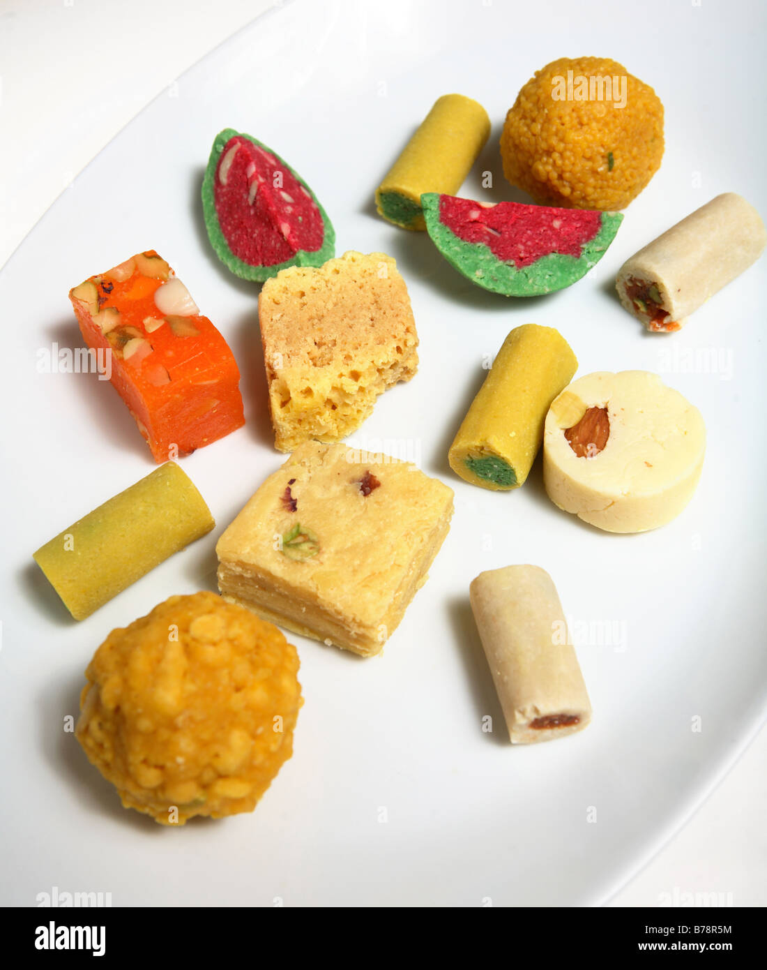 Indian (subcontinent) sweets laid out on a plate. Sweets are shared at ...