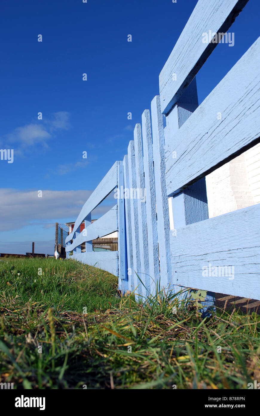 Blue fence disappearing into the distance Stock Photo - Alamy