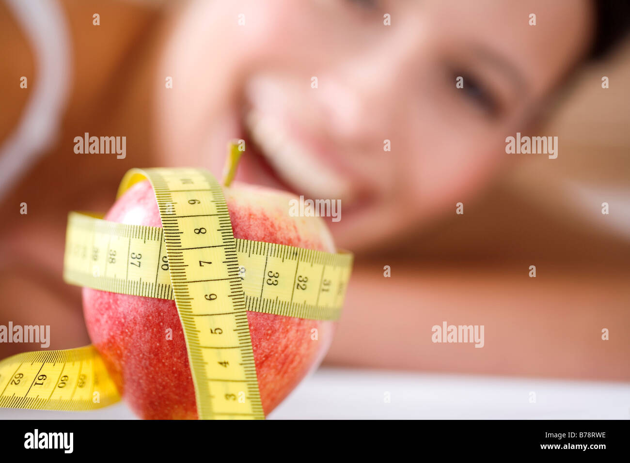 Woman wrapped in measuring tape hi-res stock photography and images - Alamy