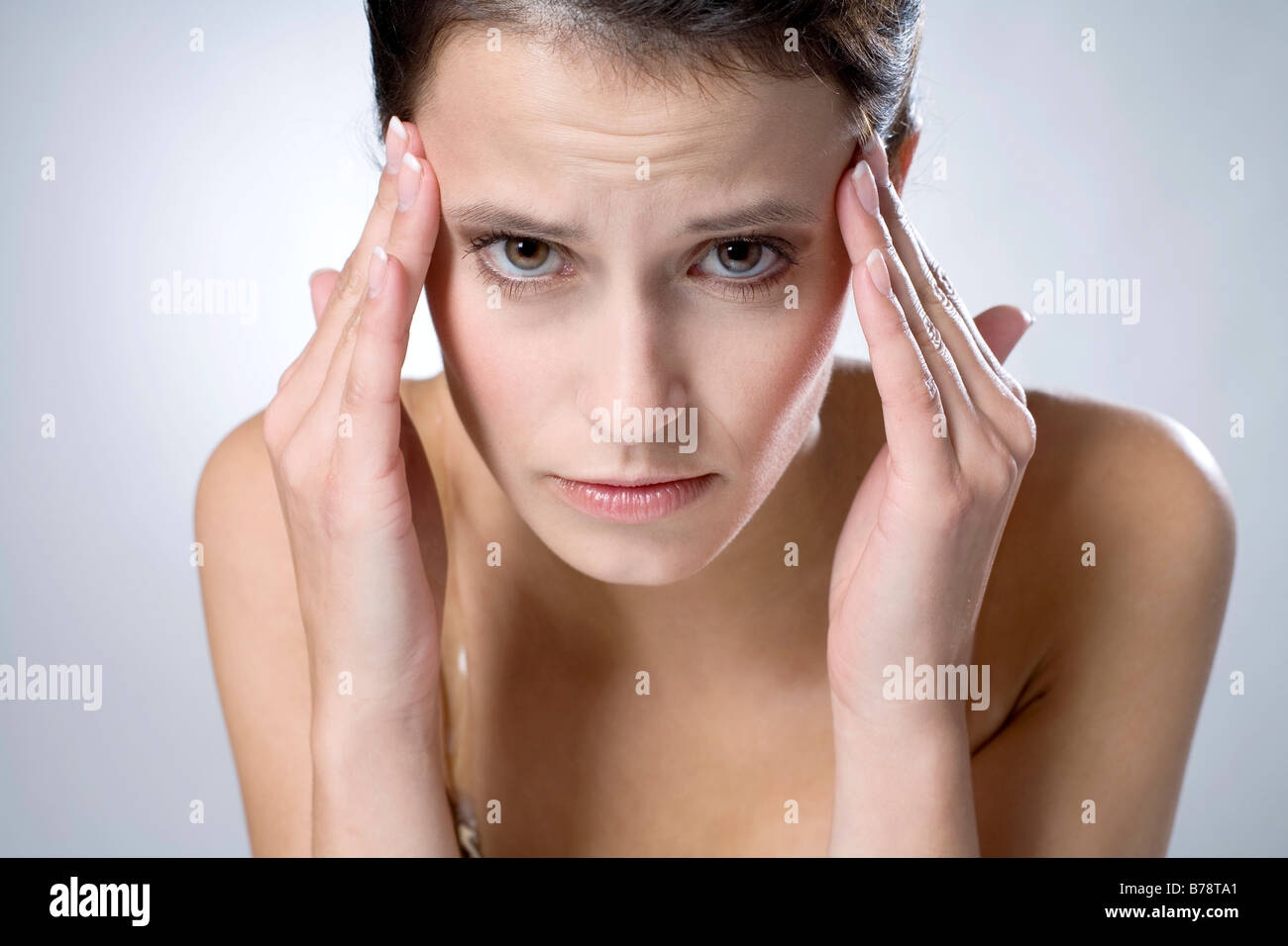 Woman, hands to forehead, close up Stock Photo - Alamy