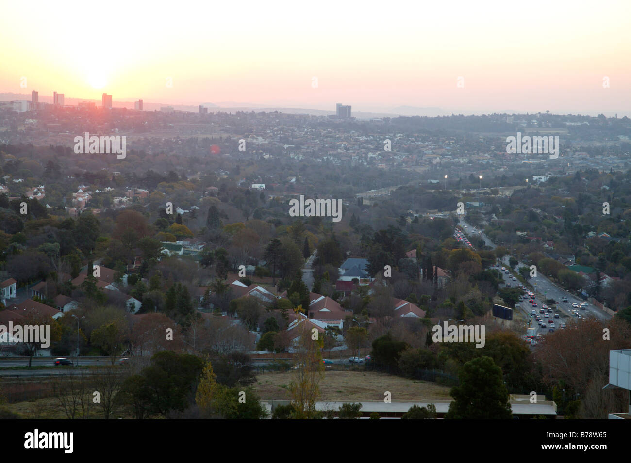 The suburbs in Sandton showing well wooded suburban homes, a busy road ...