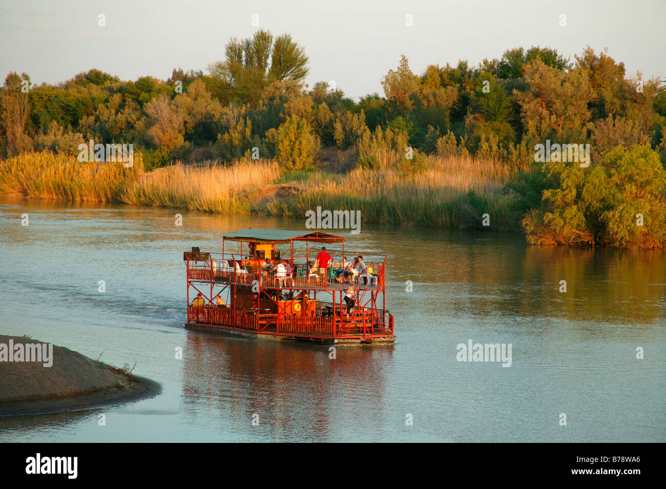 A scenic view of a boat on a sundowner cruise on the Orange river near ...