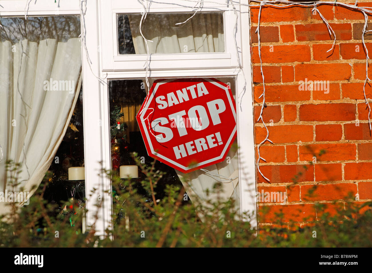 Santa Stop Here sign in window of house Stock Photo - Alamy