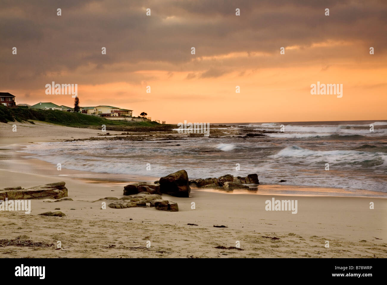 Sunrise over Haga Haga beach with Hotel and beach houses in background ...