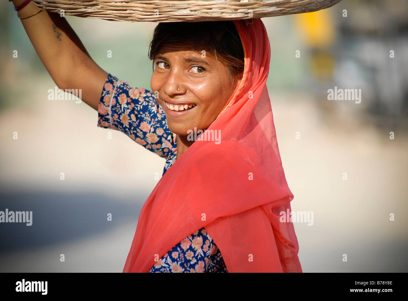 Young woman carrying a basket on her head, Pokhran, Rajasthan, North ...