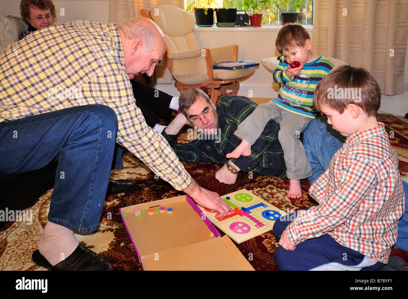 Family Group playing board game Ludo Home Stock Photo - Alamy