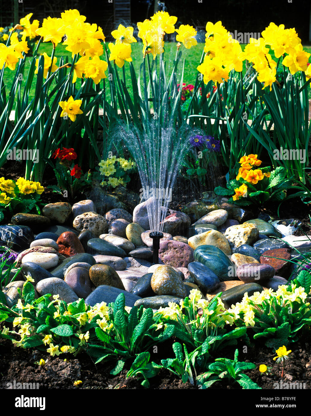 PEBBLE FOUNTAIN WITH SPRING FLOWERS Stock Photo - Alamy