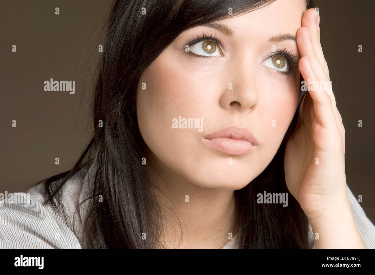 Young woman with hand on face, portrait, close-up Stock Photo - Alamy