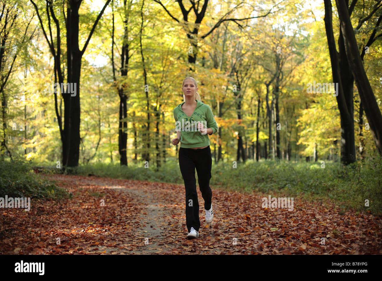 Young blonde woman jogging in the autumnal forest Stock Photo - Alamy Young blonde woman jogging in the autumnal forest Stock Photo - Alamy