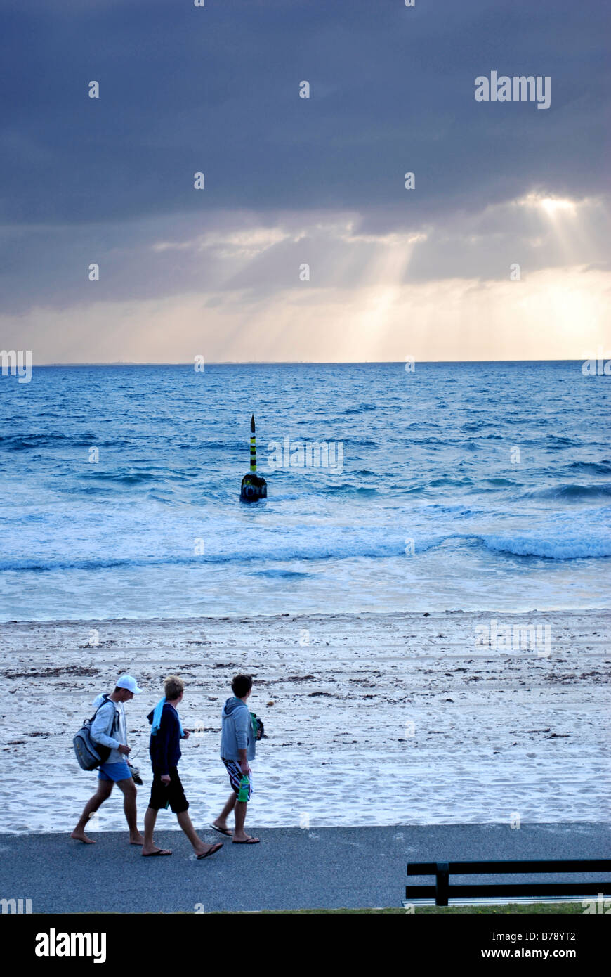 Three men on a beach Stock Photo - Alamy