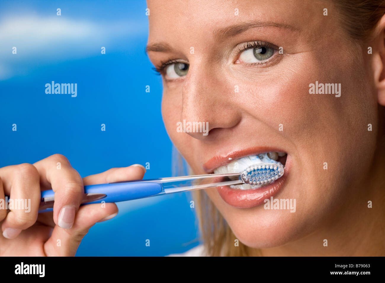 Young woman brushing teeth, portrait Stock Photo - Alamy