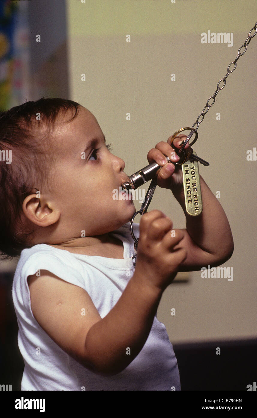 The baby of a prisoner plays with the keys of a prison warden, which ...