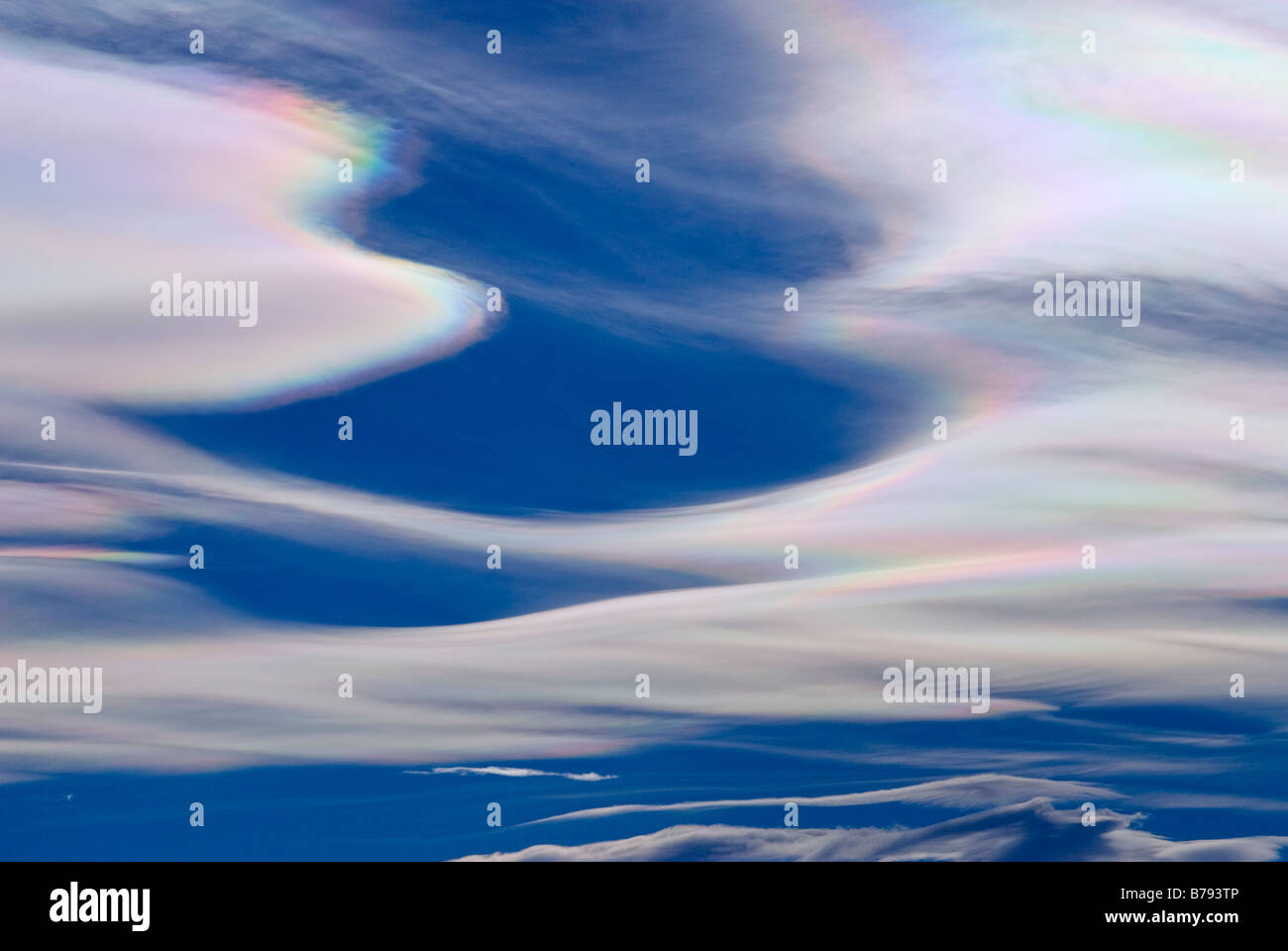 stationary, lens shaped lenticular clouds forming at high altitude with ...