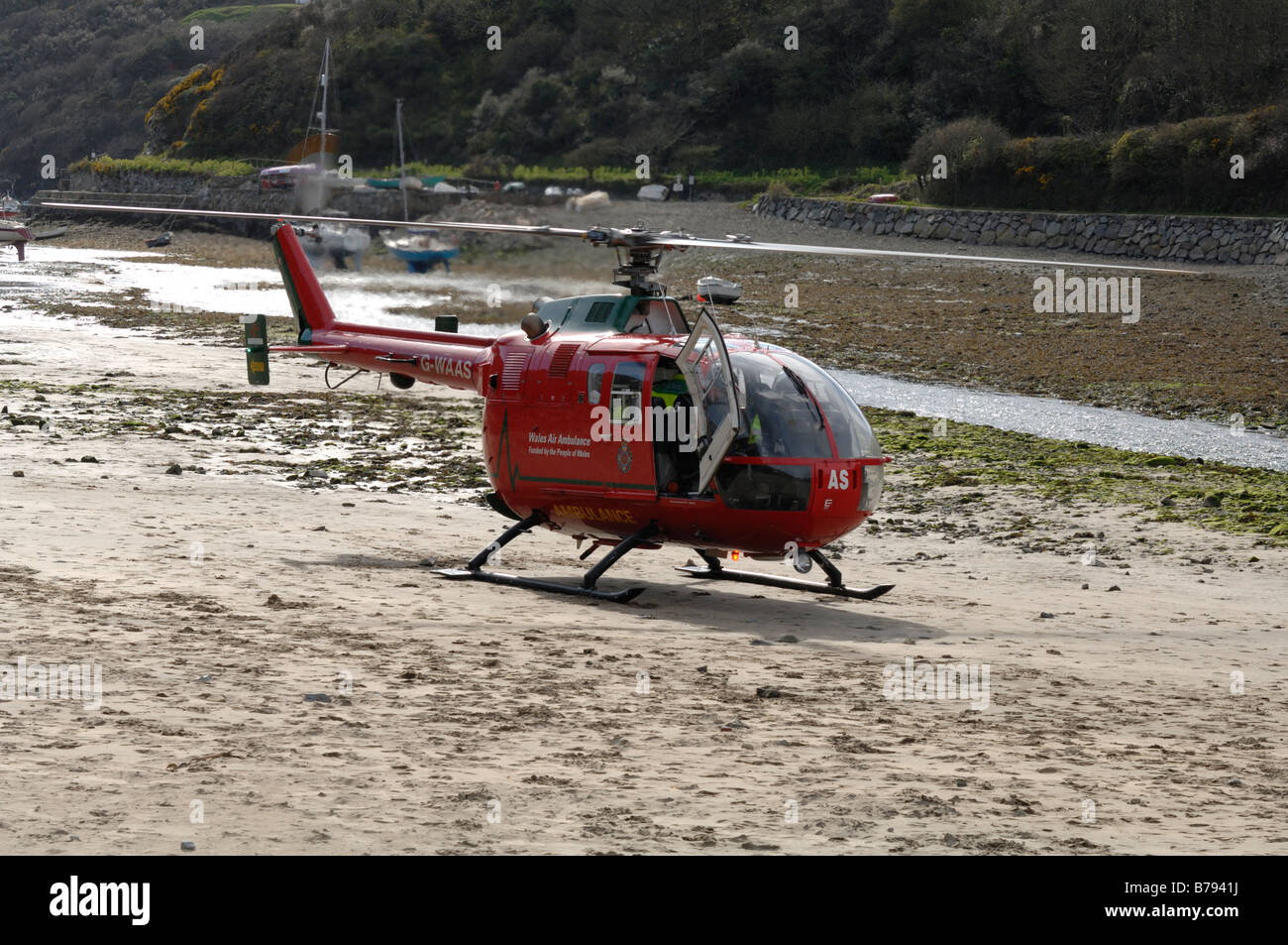Wales Air Ambulance helicopter and crew rescuing a casualty at Solva ...