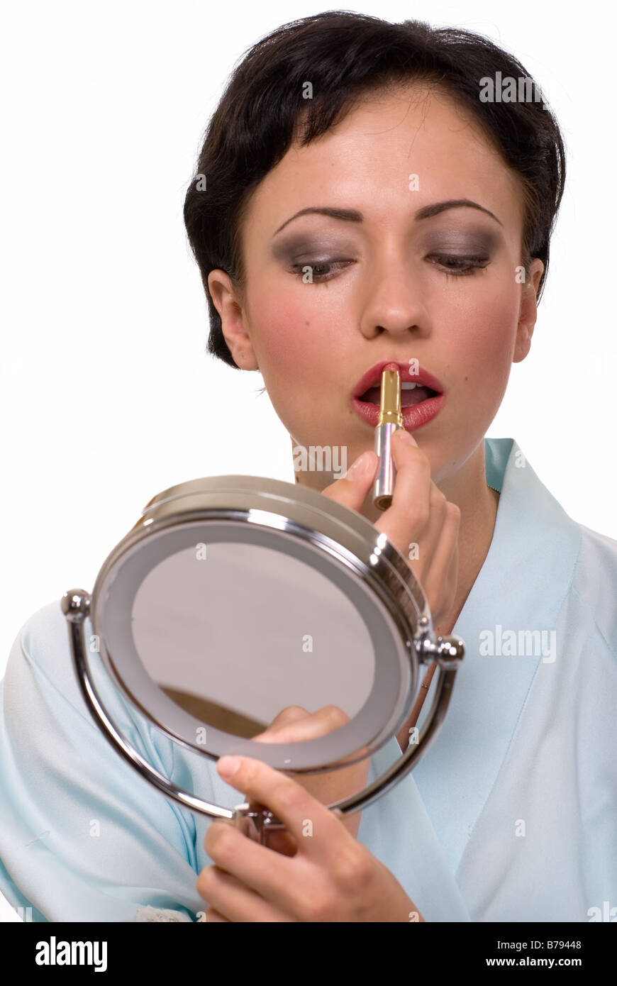 Woman applying lipstick Stock Photo - Alamy