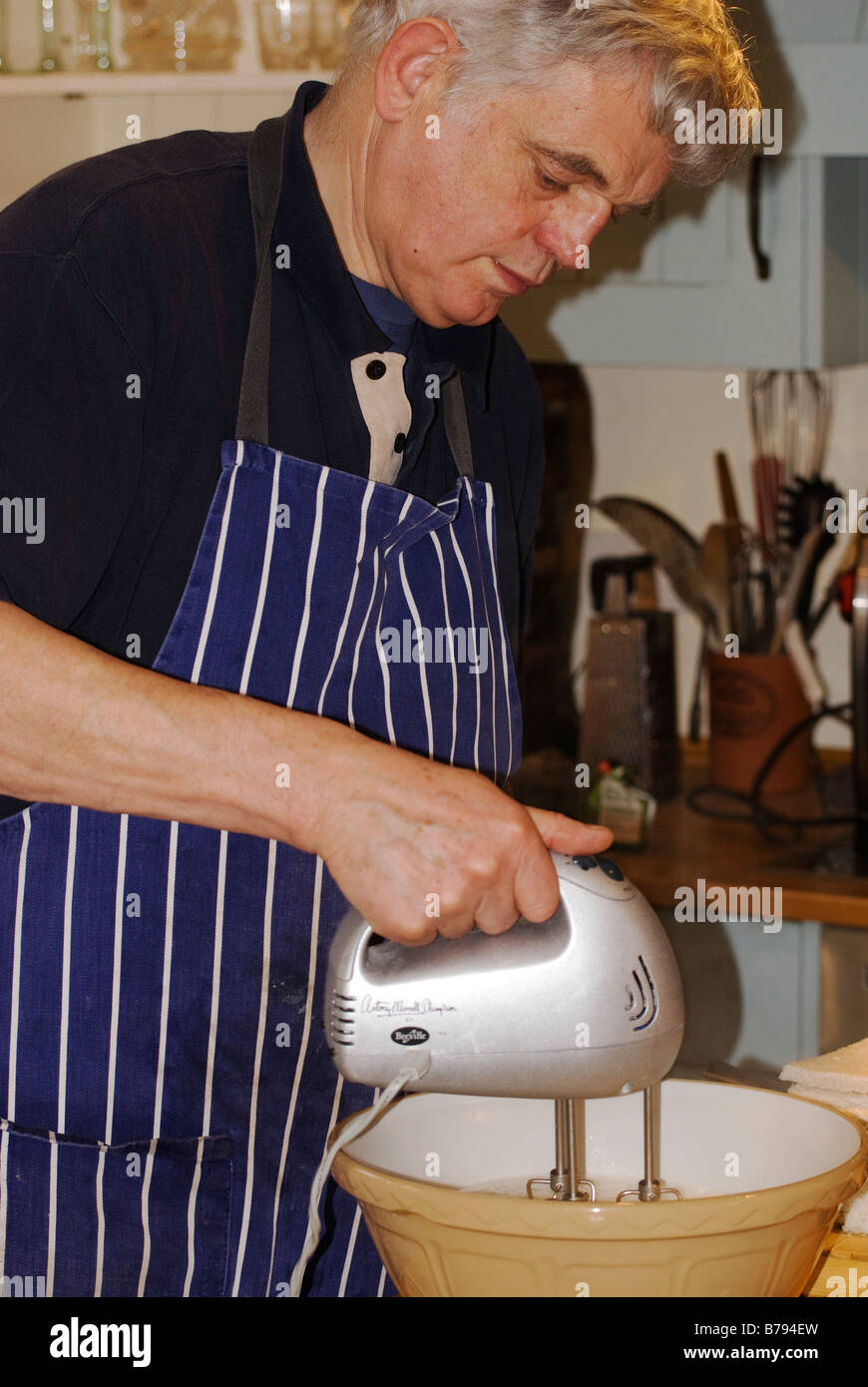 man mixing cake with electric whisk Stock Photo - Alamy