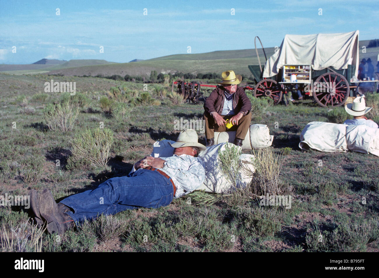 Cowboys on a cattle drive snooze on their cowboy bedrolls and wait for ...