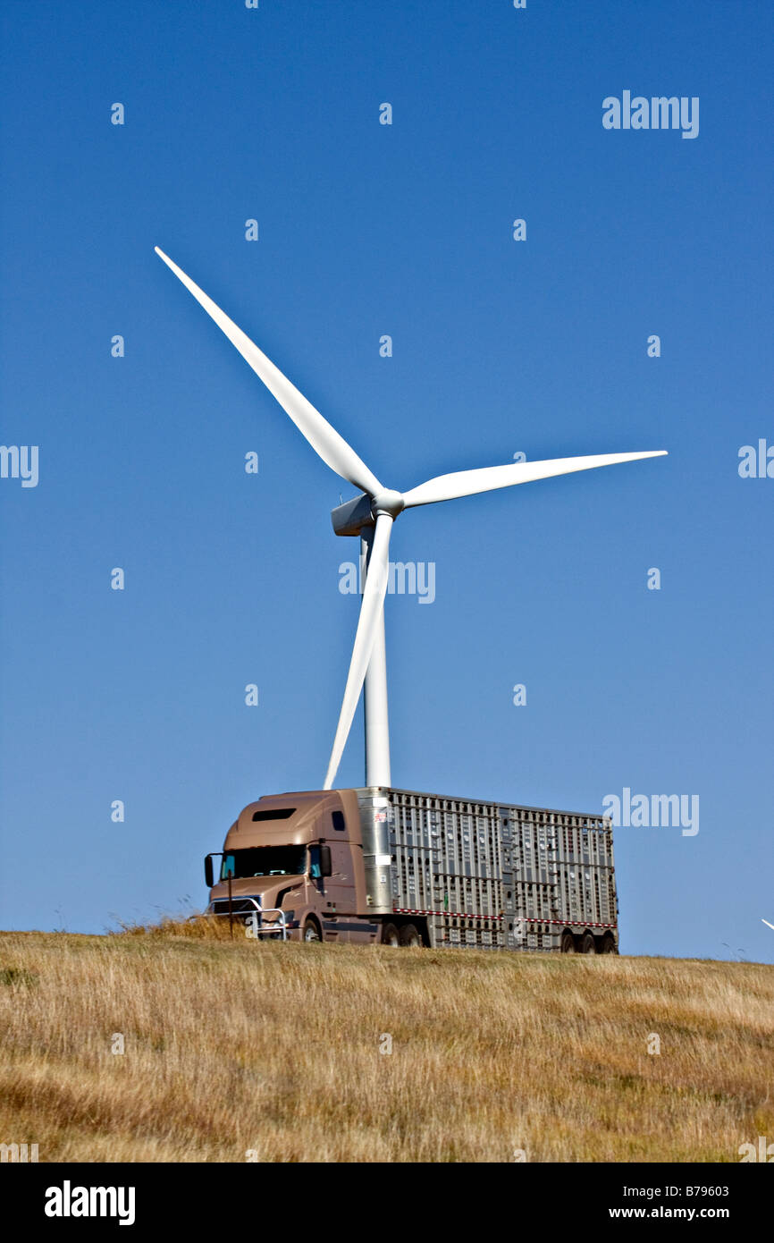 A semi truck passes in front of a wind turbine Stock Photo - Alamy