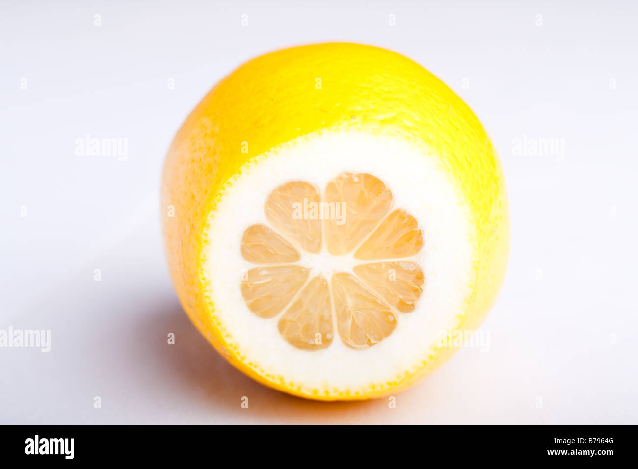 Single lemon with end cut off Stock Photo - Alamy