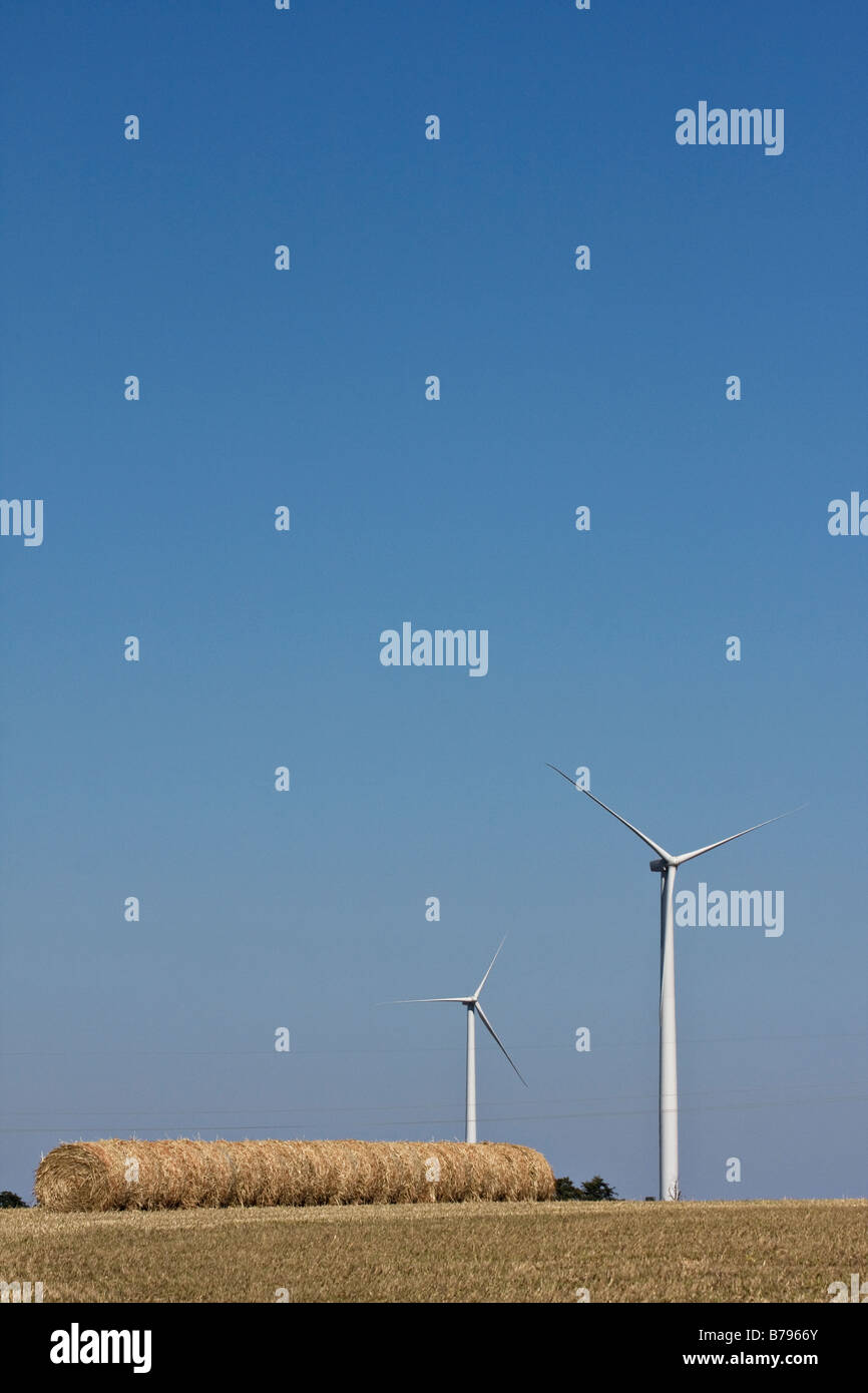 Wind turbines stand next to hay bales in Kansas Stock Photo - Alamy
