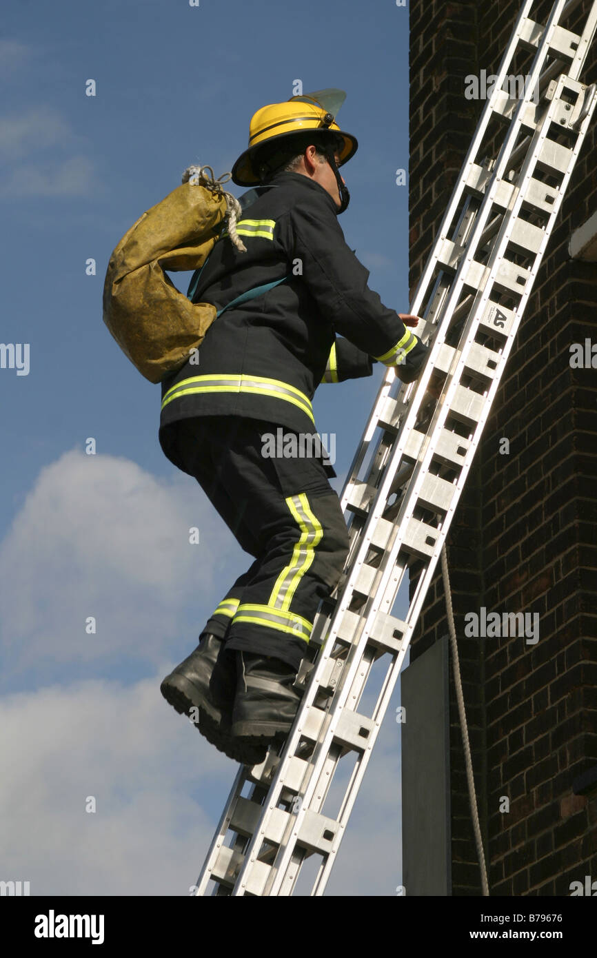 Fireman climbing a ladder hi-res stock photography and images - Alamy