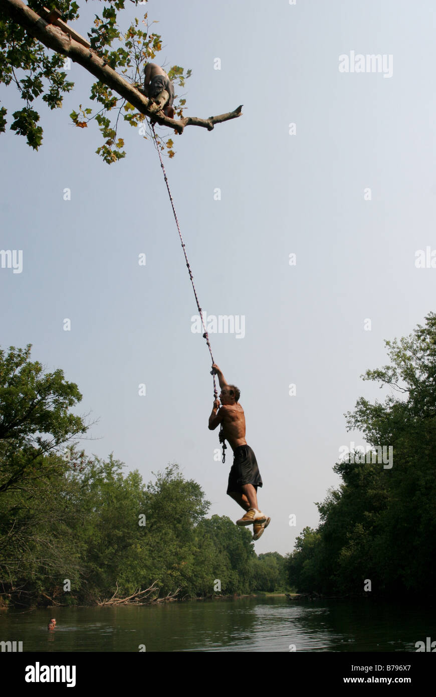 Teens rope swinging Little Miami River Ohio Stock Photo - Alamy